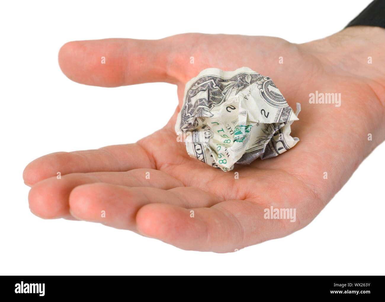 Male hand holding crumpled dollar photographed on a white background ...