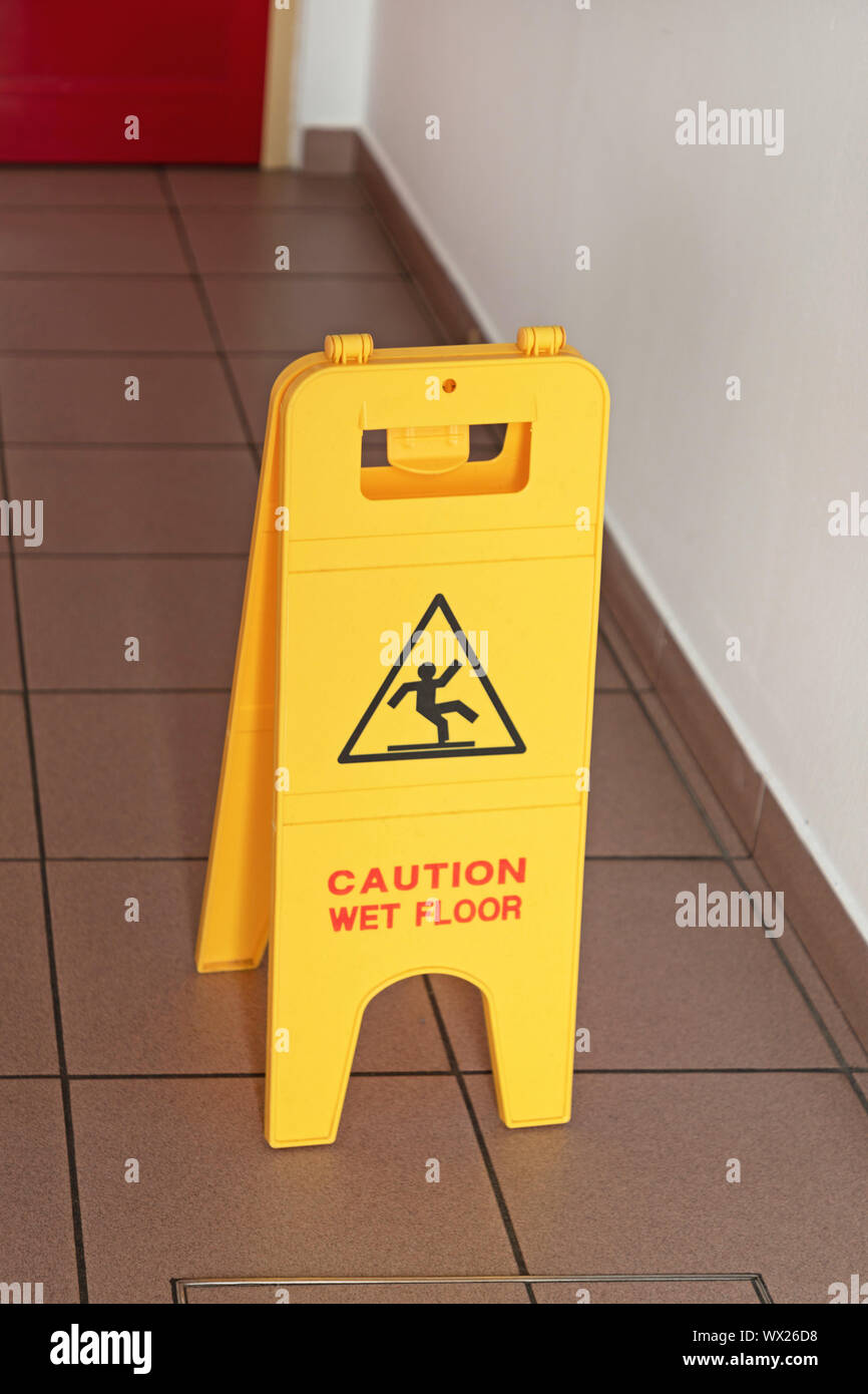 Yellow Plastic Warning Sign Caution Wet Floor Stock Photo - Alamy