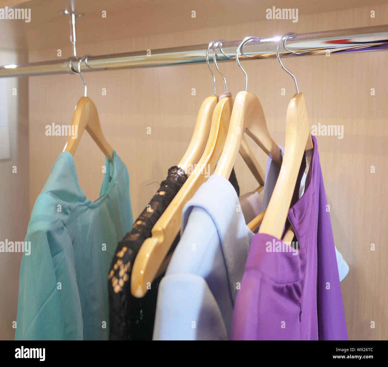 Clothes in wardrobe Stock Photo - Alamy