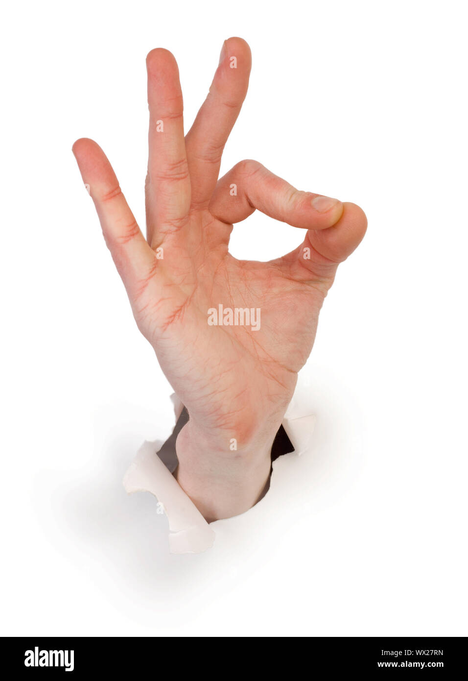 Gesture male hand through white paper photographed on a white ...