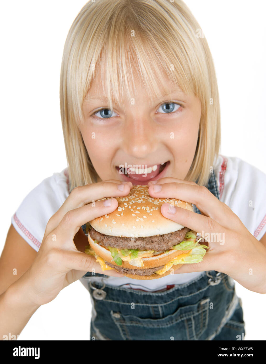 Happy Little Girl Eating Hamburger Stock Photo - Alamy
