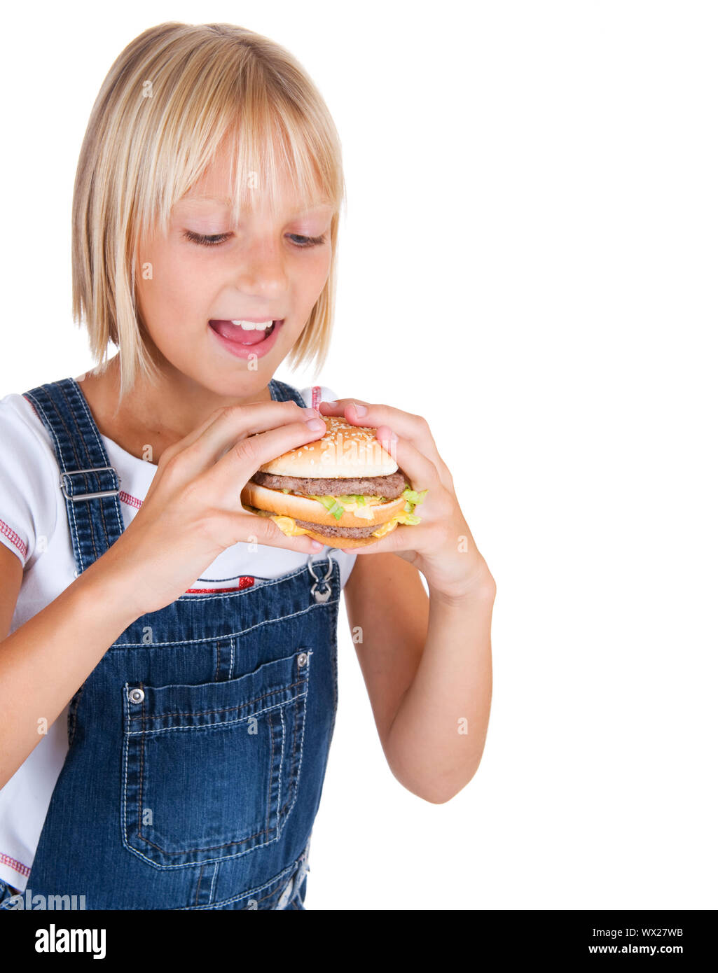 Happy Little Girl Eating Hamburger Stock Photo - Alamy