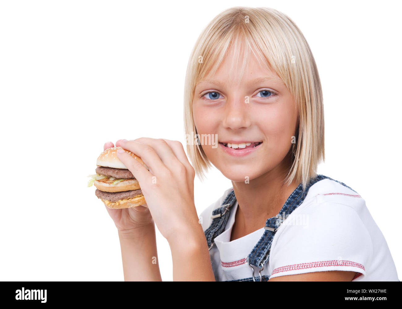Happy Little Girl Eating Hamburger Stock Photo - Alamy