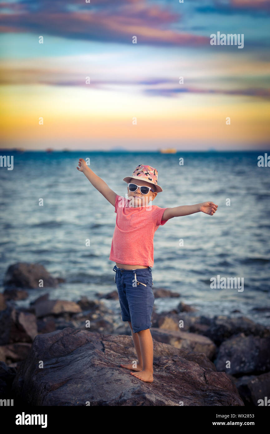 Little boy on the rock Stock Photo - Alamy