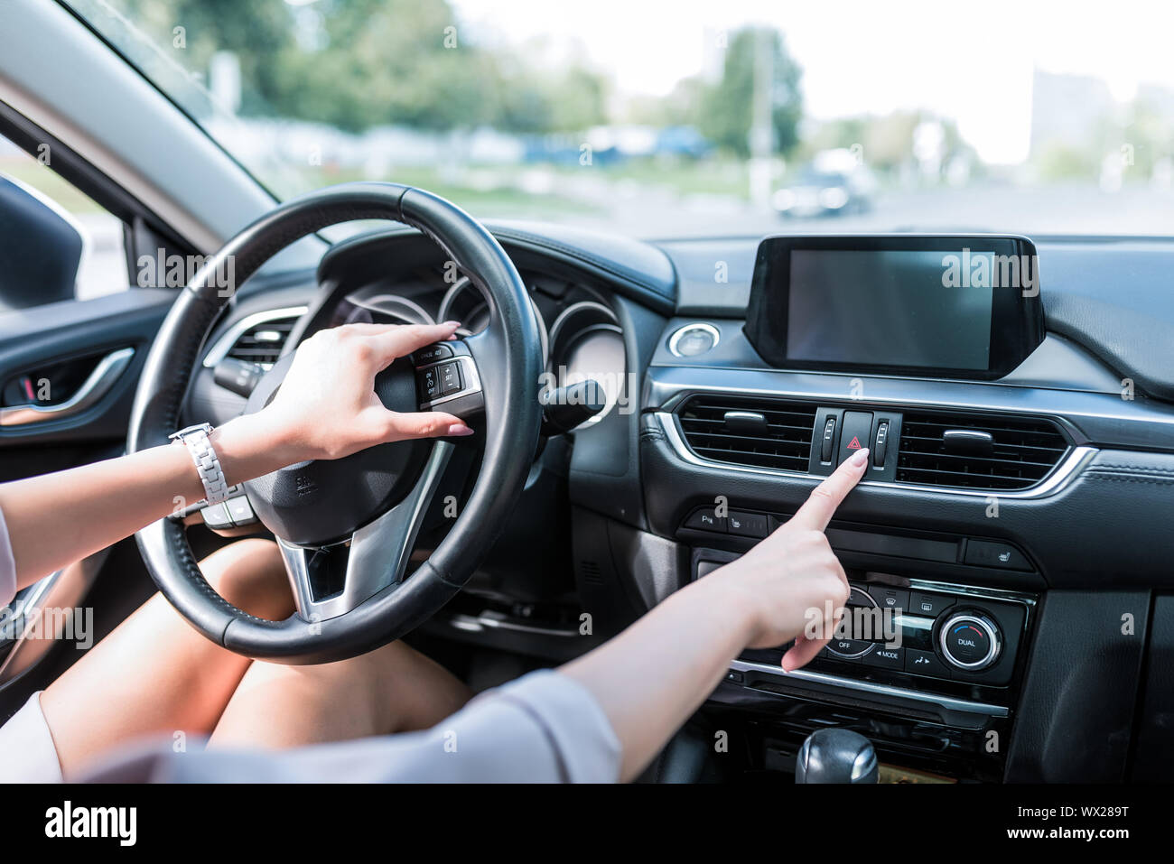 Close-up, female hand includes an emergency stop button, turning on ...