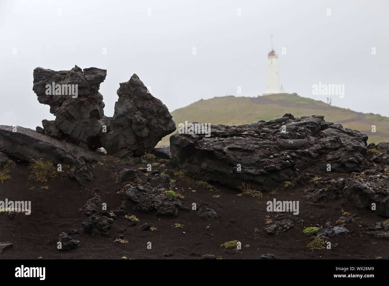 Lava with the lighthouse Reykjanesviti on the southwestern tip ...