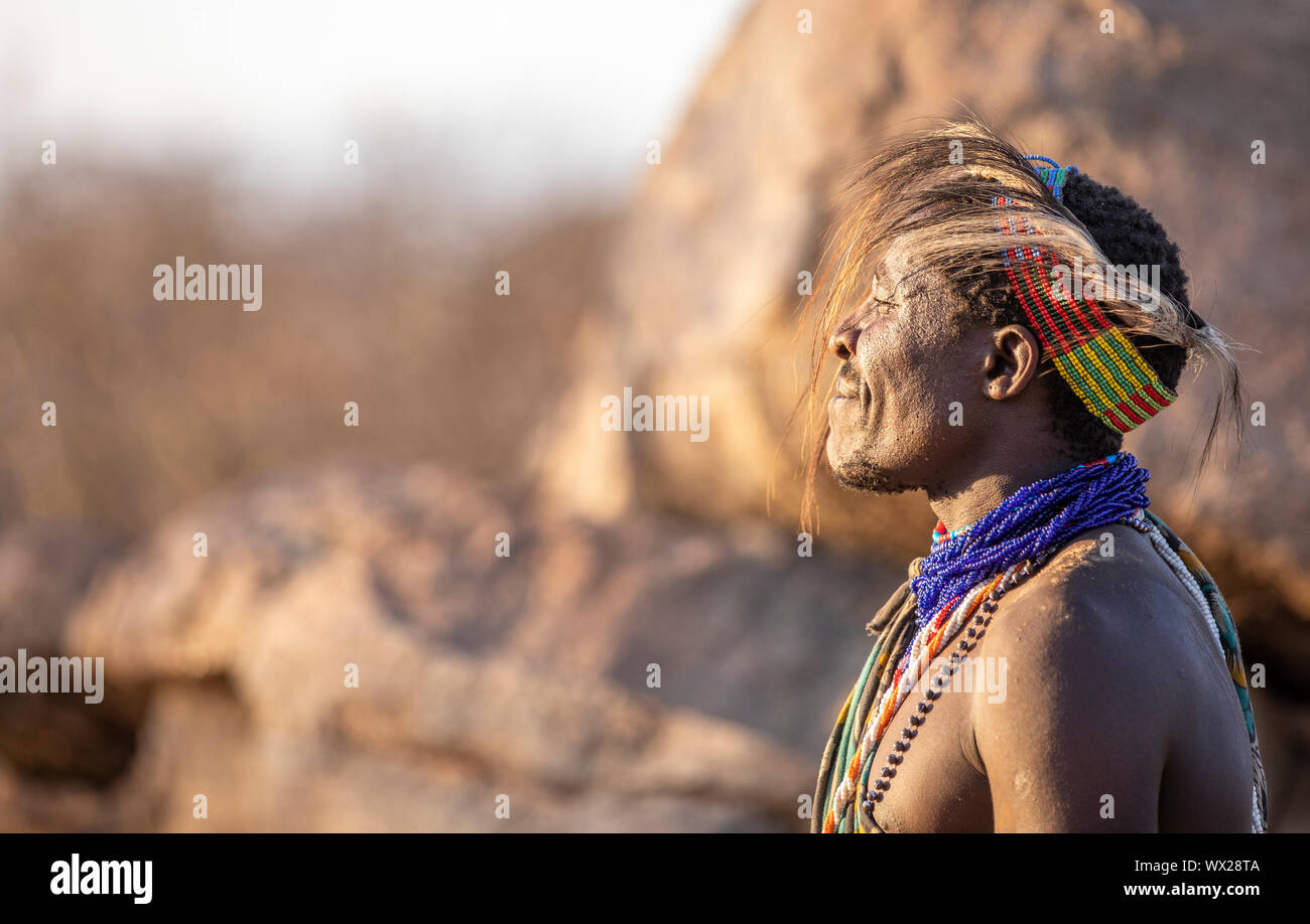 Lake Eyasi, Tanzania, 11th September 2019: Hadzabe man resting with his ...
