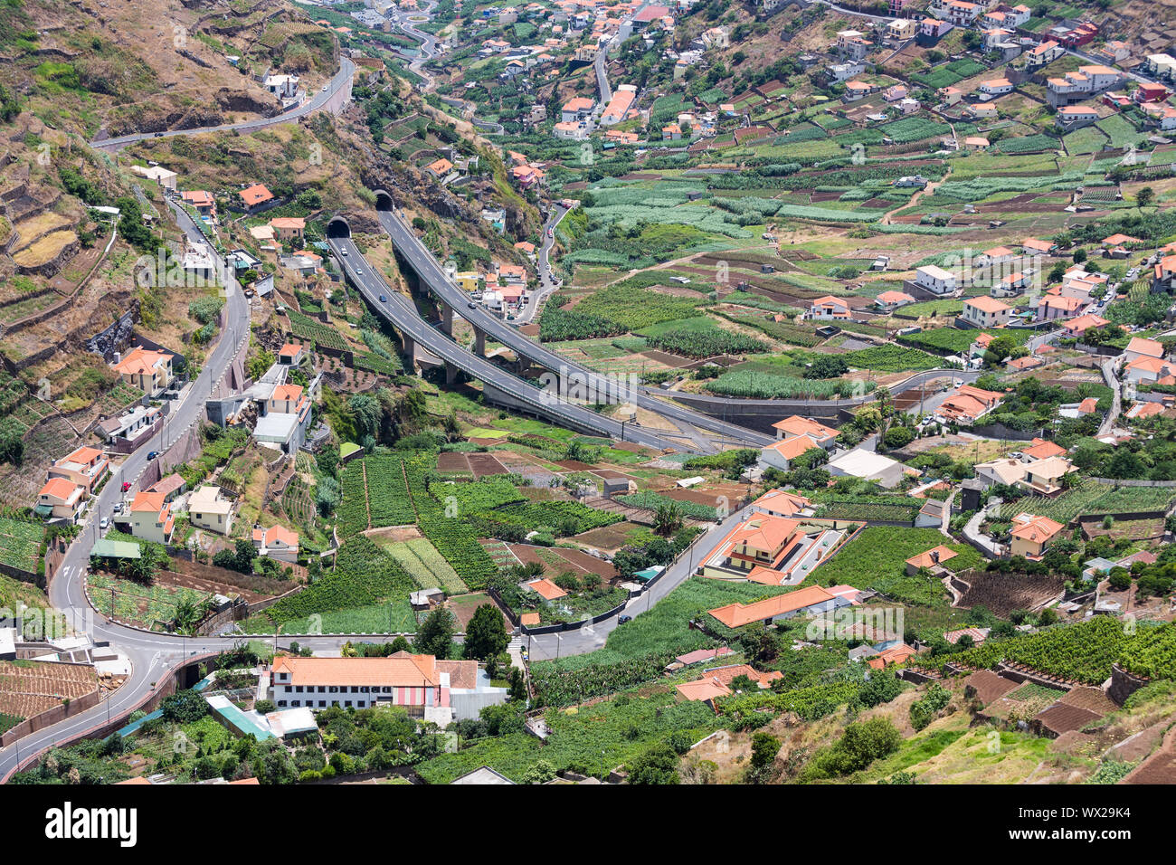Aerial view of little villages and a highway in the mountains of ...