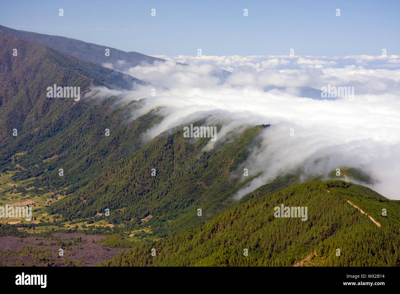Clouds falling over the mountain ridge of La Palma, Canary Islands ...
