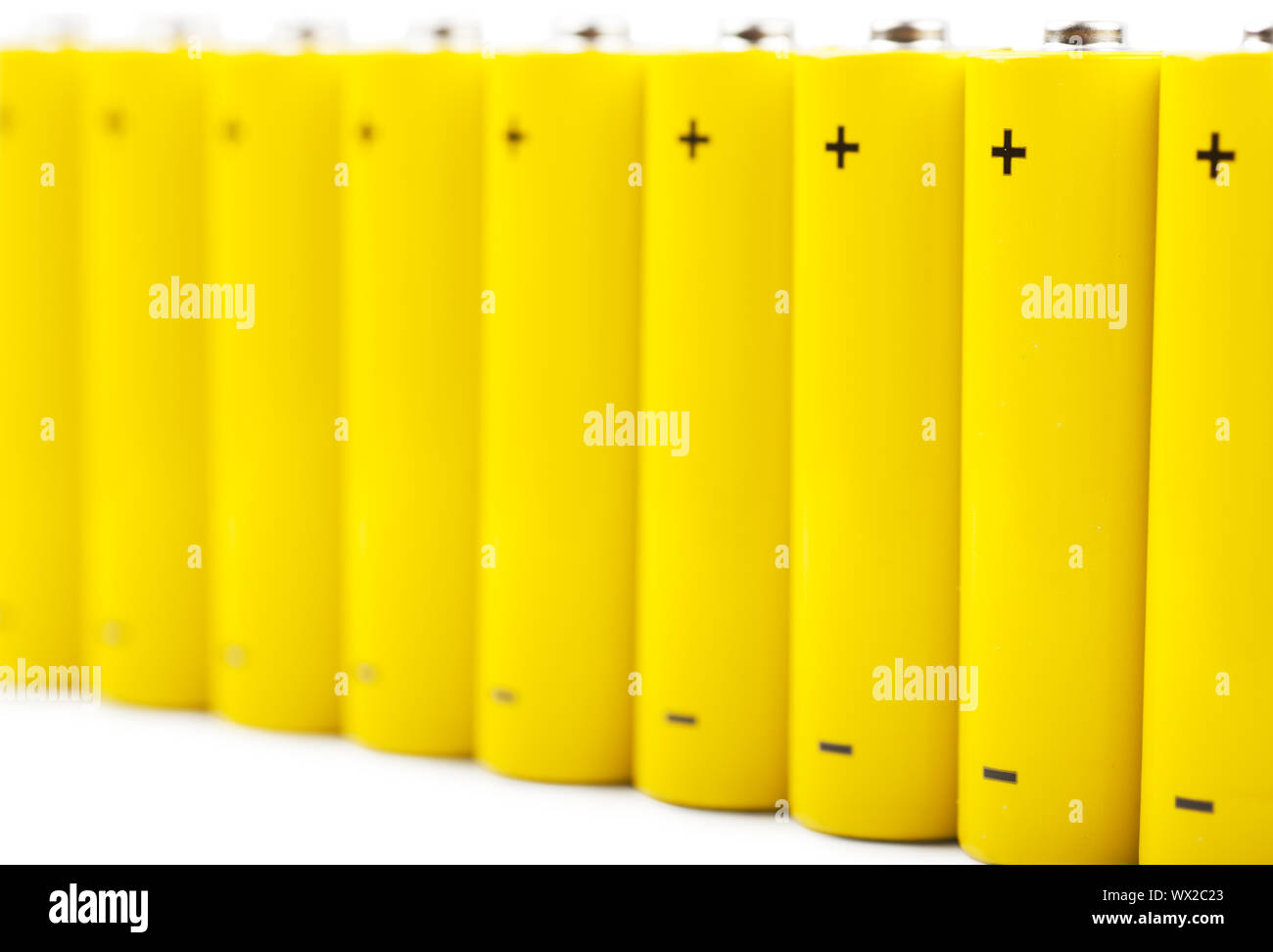 A row of yellow batteries isolated over white background Stock Photo ...