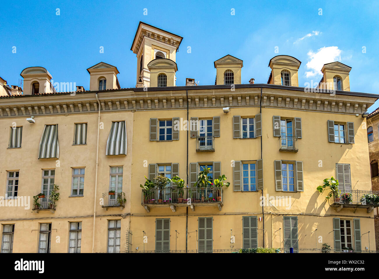 Italian apartment building with window boxes with flowers and windows ...
