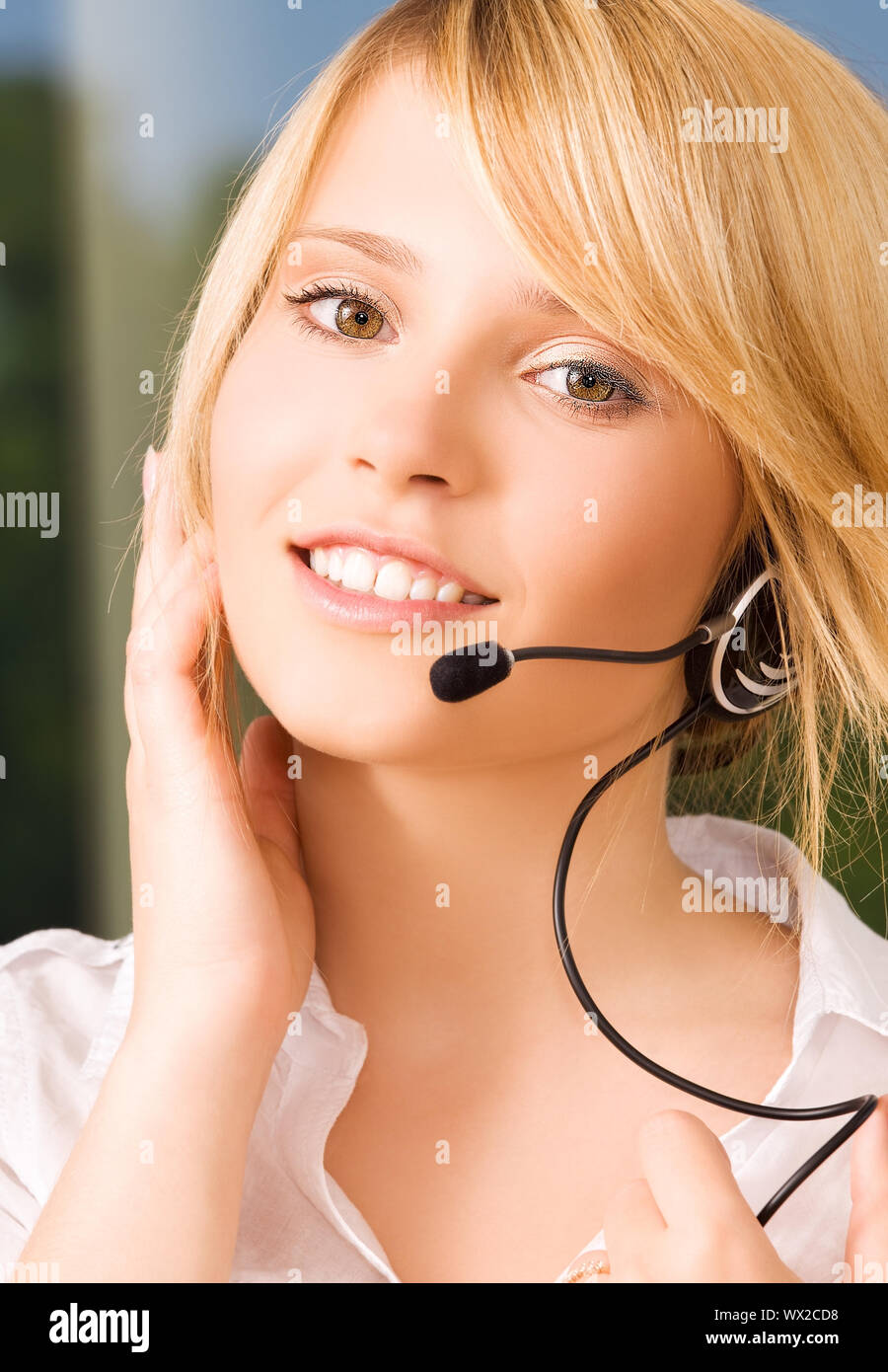 bright picture of friendly female helpline operator Stock Photo - Alamy