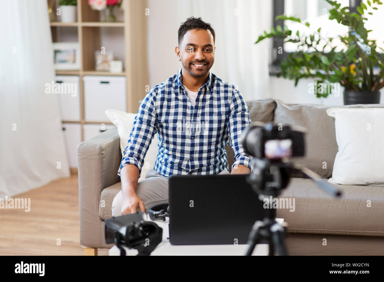 male blogger with camera videoblogging at home Stock Photo - Alamy