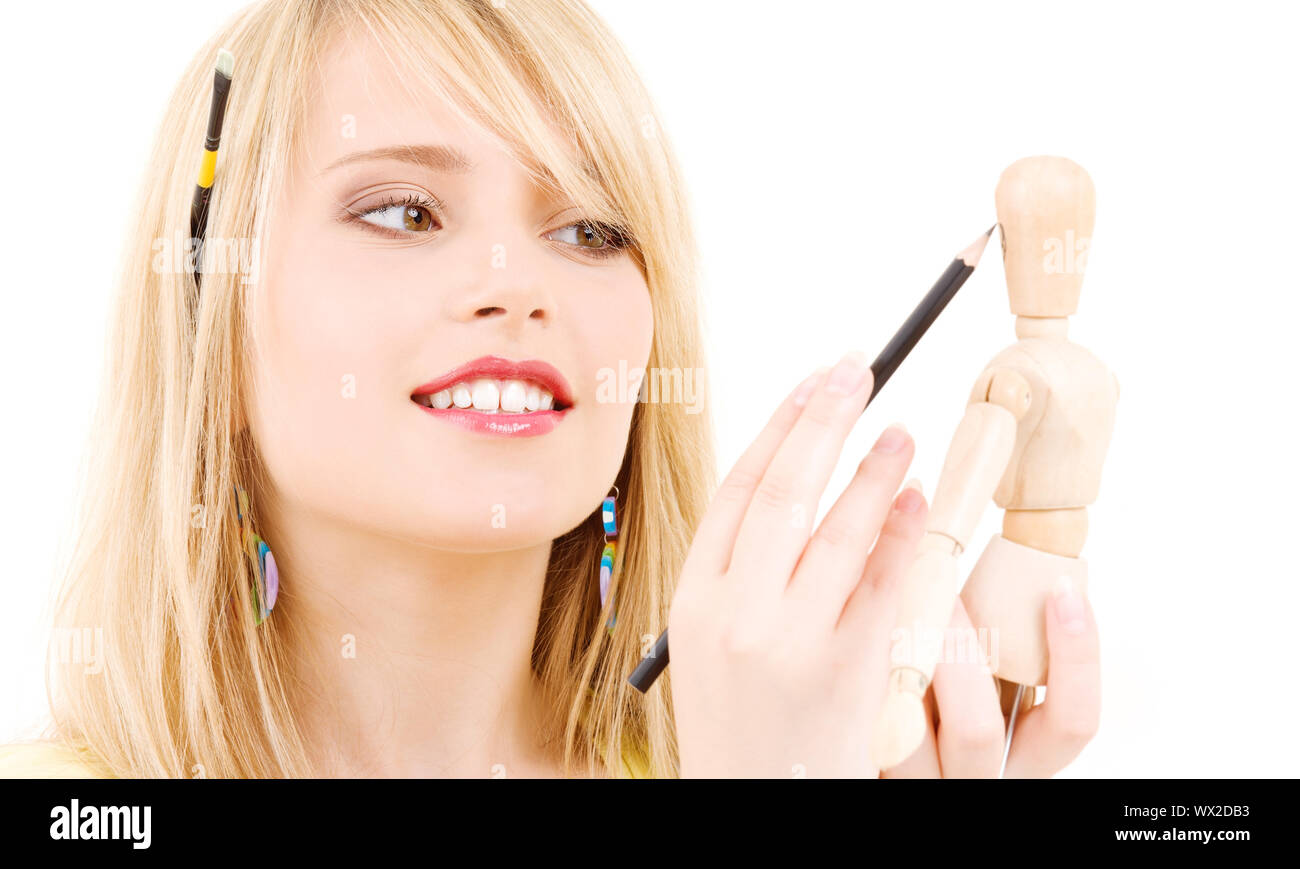 happy teenage girl with wooden model dummy over white Stock Photo - Alamy