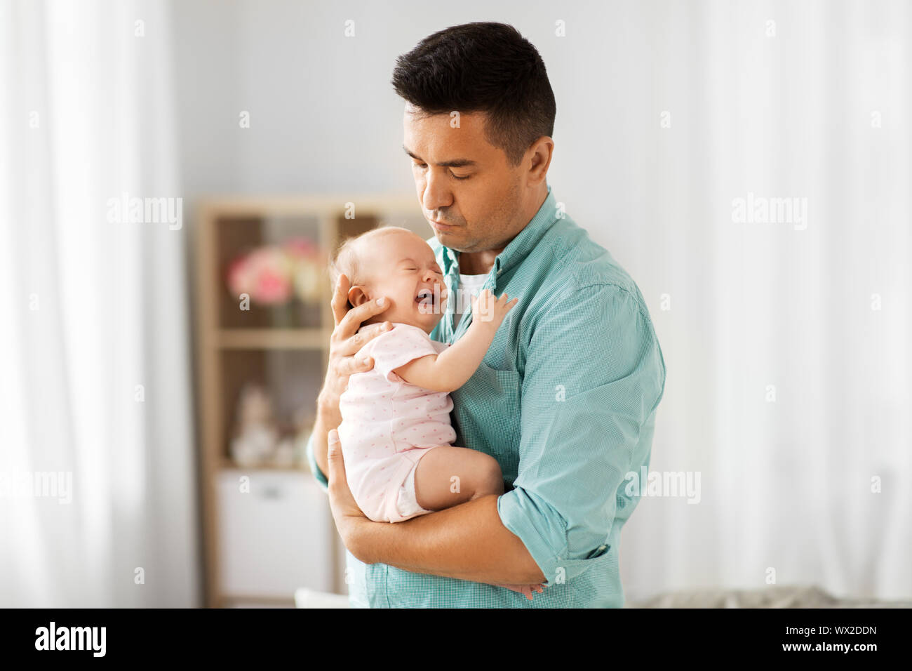 middle aged father with baby daughter at home Stock Photo - Alamy
