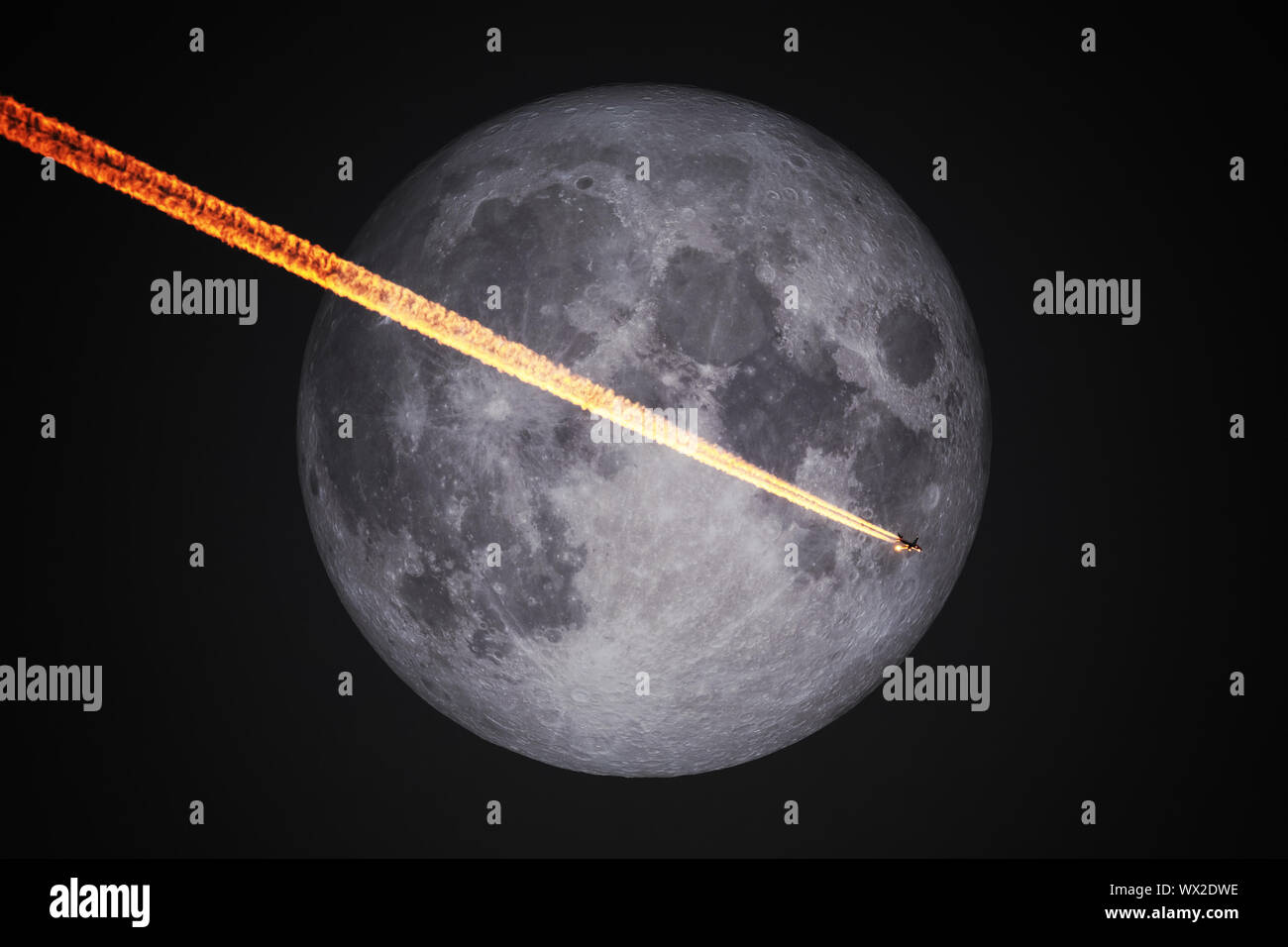 a plane flight in front of the full moon by night sky Stock Photo - Alamy