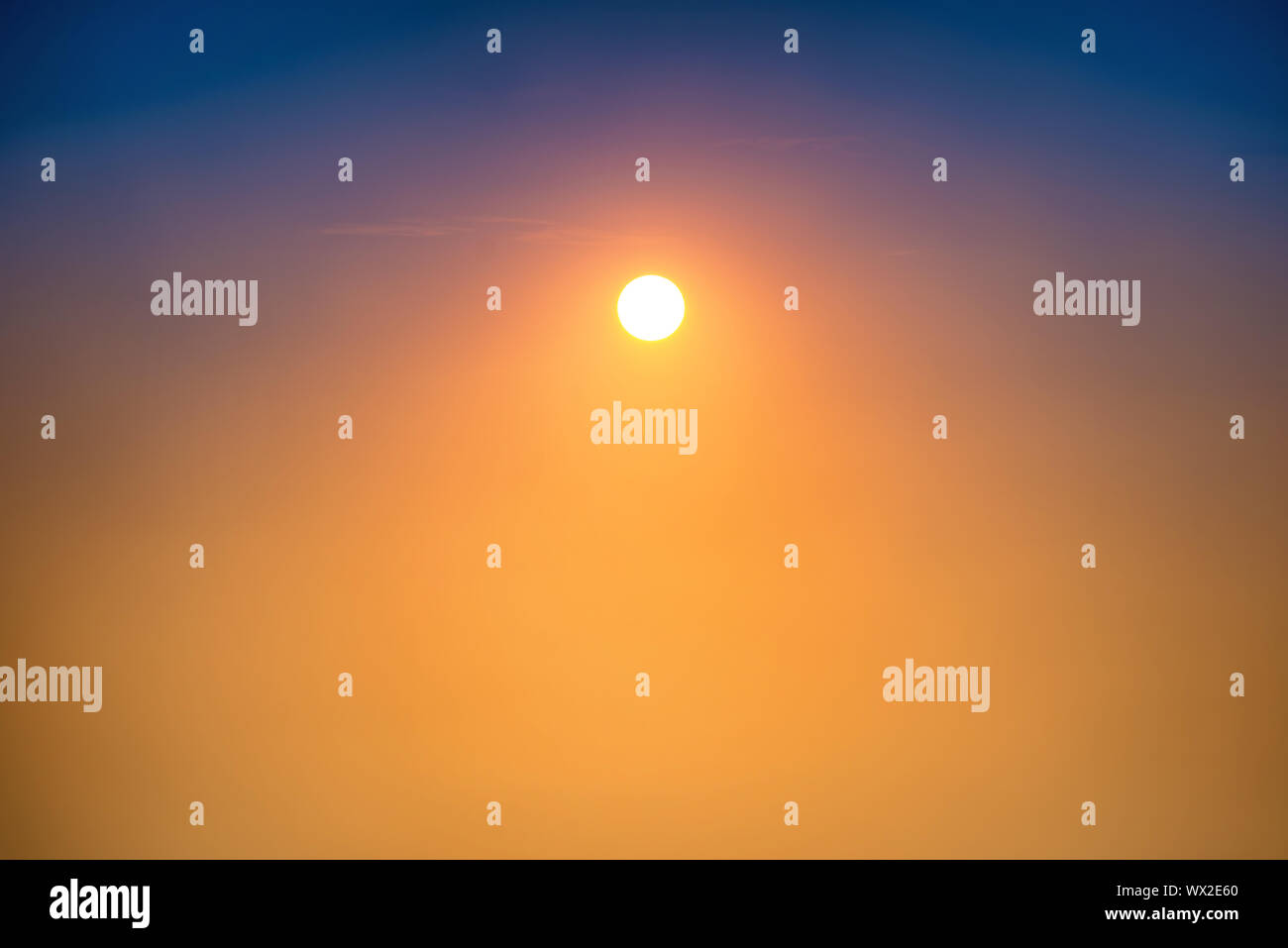 Sunset in the sky with big sun Stock Photo - Alamy