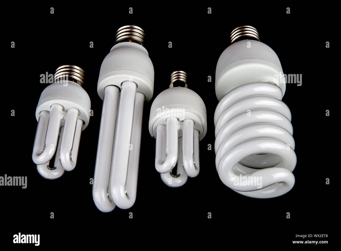 Selection of energy efficient lamps isolated against a black background ...