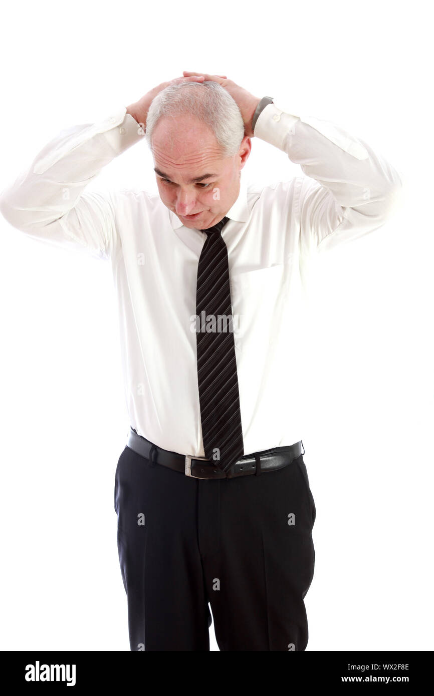 An elderly businessman who is stressed out. He claps his hands over his ...