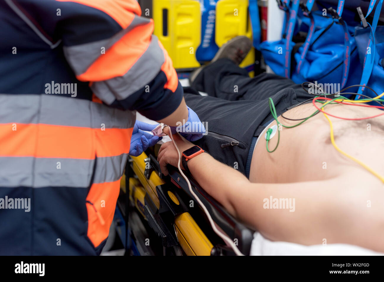 Emergency doctor checking pulse of a patient in the ambulance Stock ...