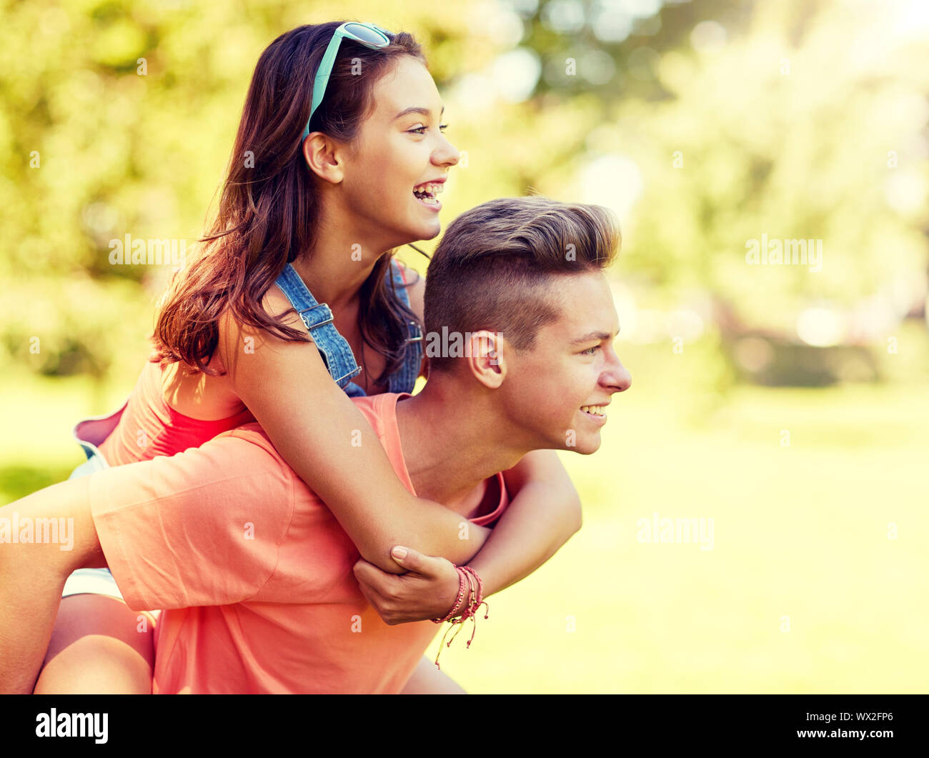 happy teenage couple having fun at summer park Stock Photo - Alamy