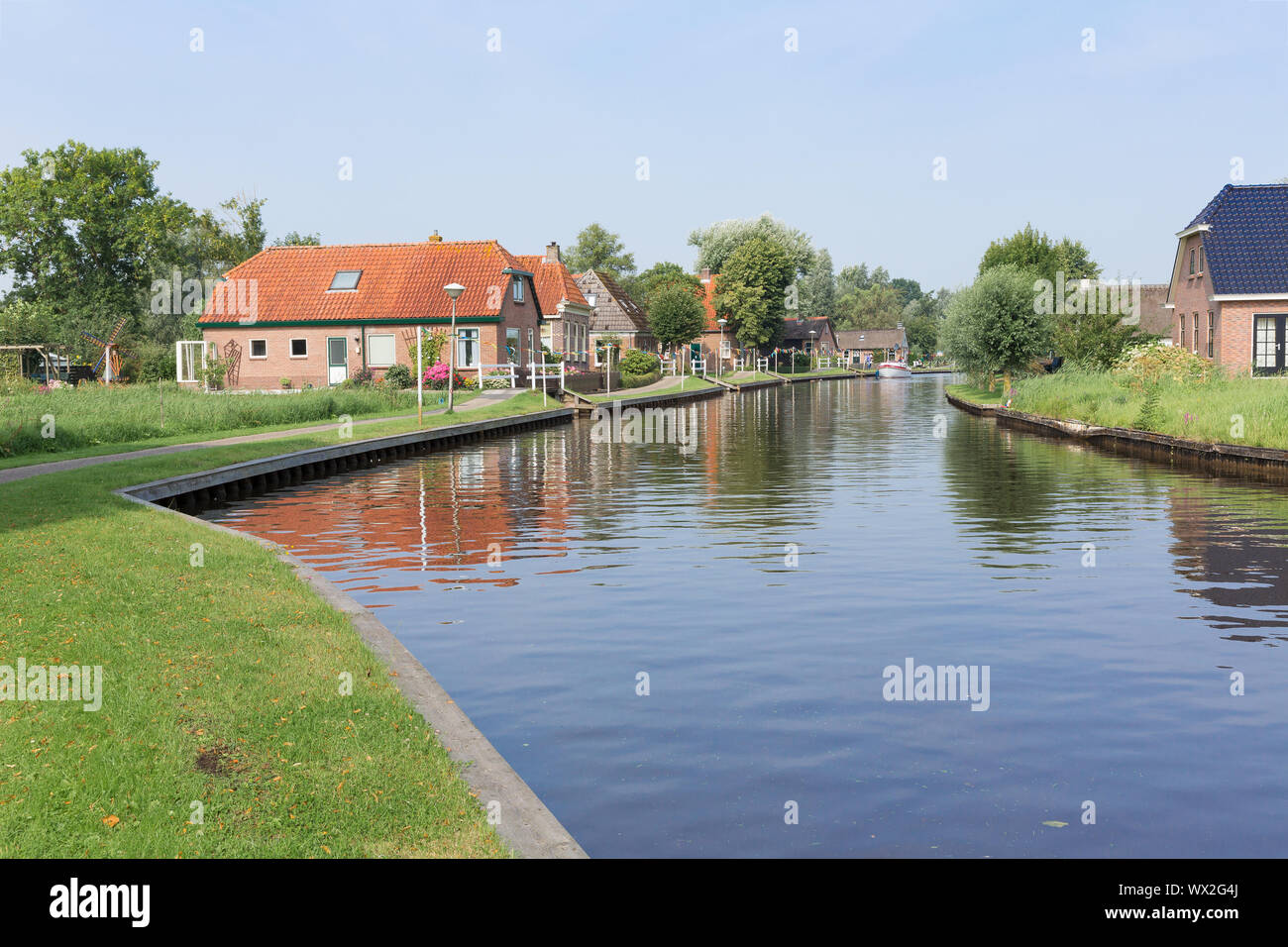 Canal with houses in rural landscape near Giethoorn, the Netherlands ...