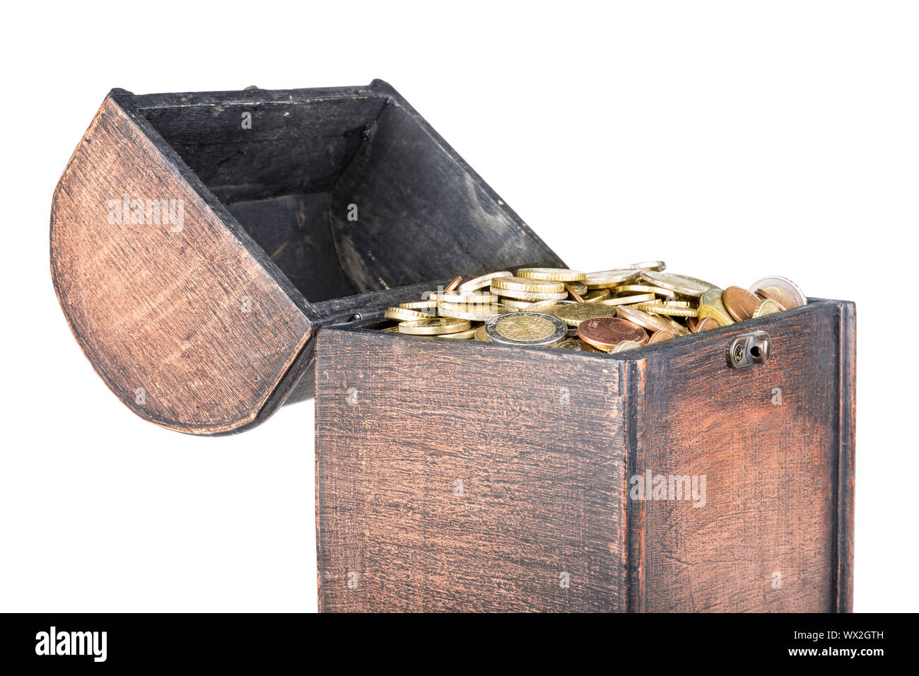 Wooden money chest filled with coins isolated at a white background ...