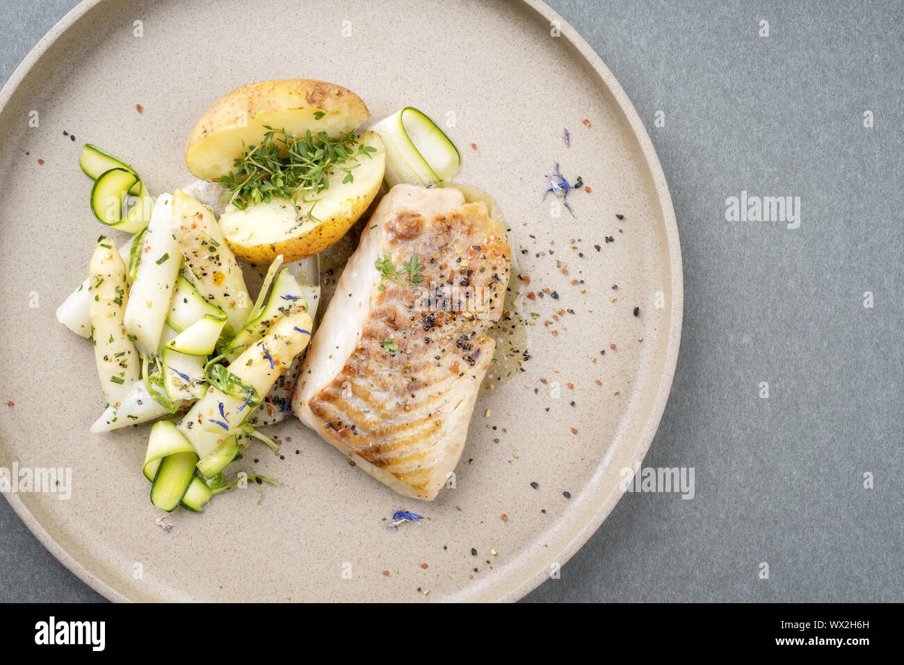 Modern German fried cod fish filet with white asparagus tips and roast ...