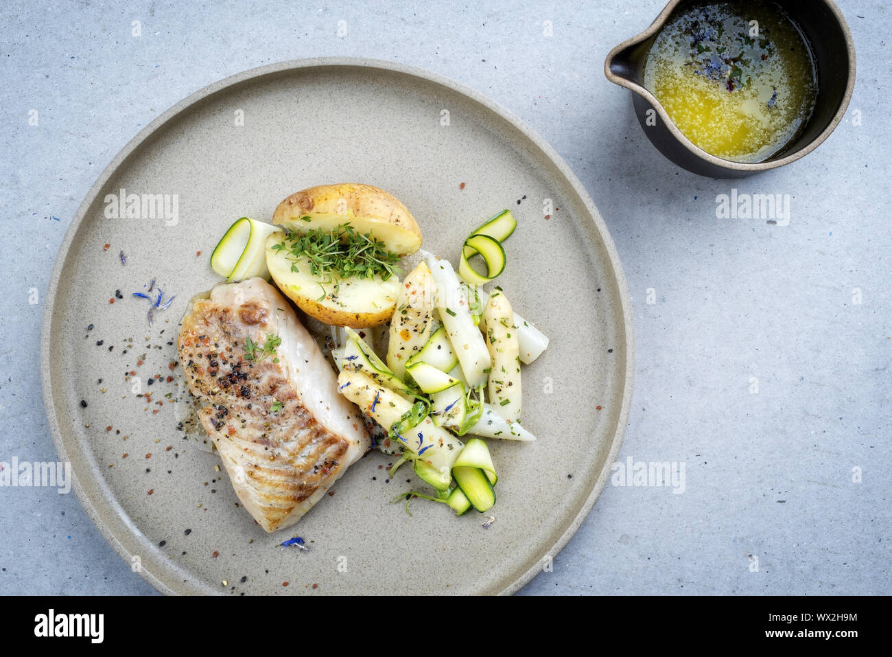 Modern German fried cod fish filet with white asparagus tips and roast ...