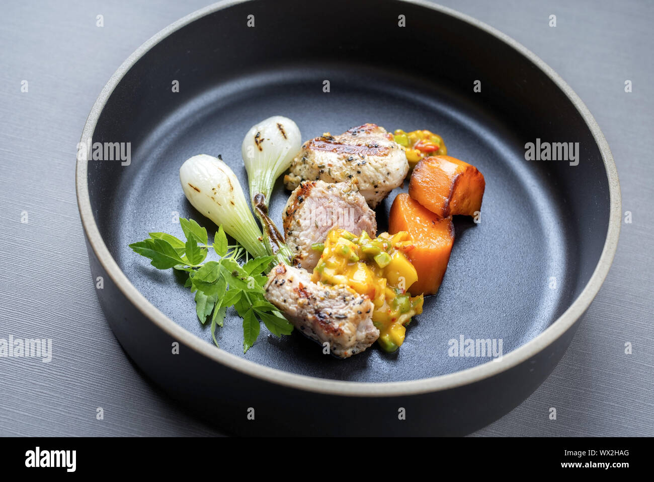 Modern barbecue crocodile tail eye fillet with roasted sweet potatoes ...
