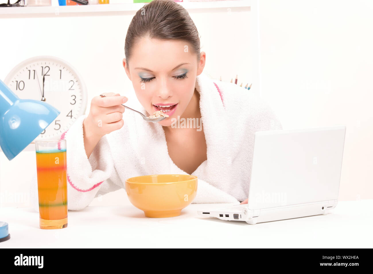 picture of eating woman with laptop computer Stock Photo - Alamy