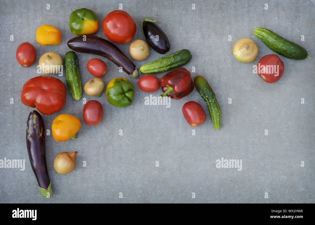 Variety of fresh vegetables on grey background Stock Photo - Alamy