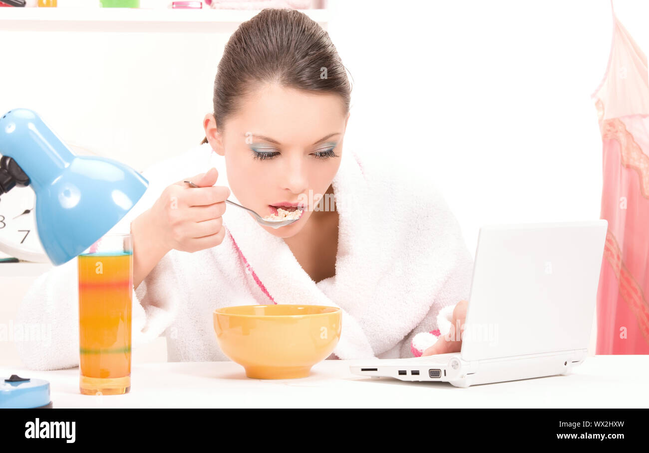picture of eating woman with laptop computer Stock Photo - Alamy