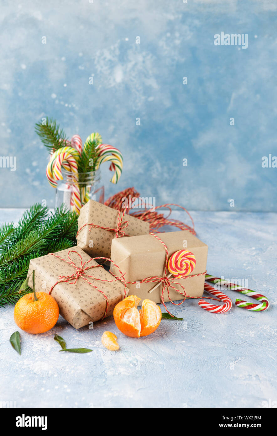 Christmas gift box, candy cane, tangerines and fir tree branch Stock ...