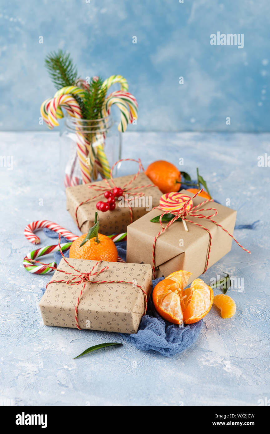Christmas gift box, candy cane, tangerines and fir tree branch Stock ...