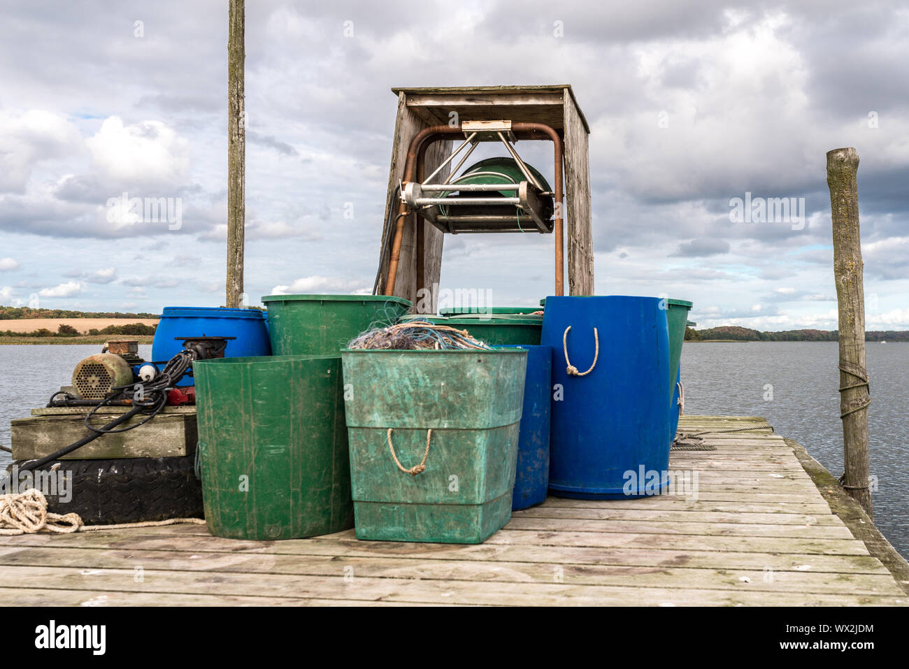Fisher net and rope in barrels on a pier on Rügen Island Stock Photo ...