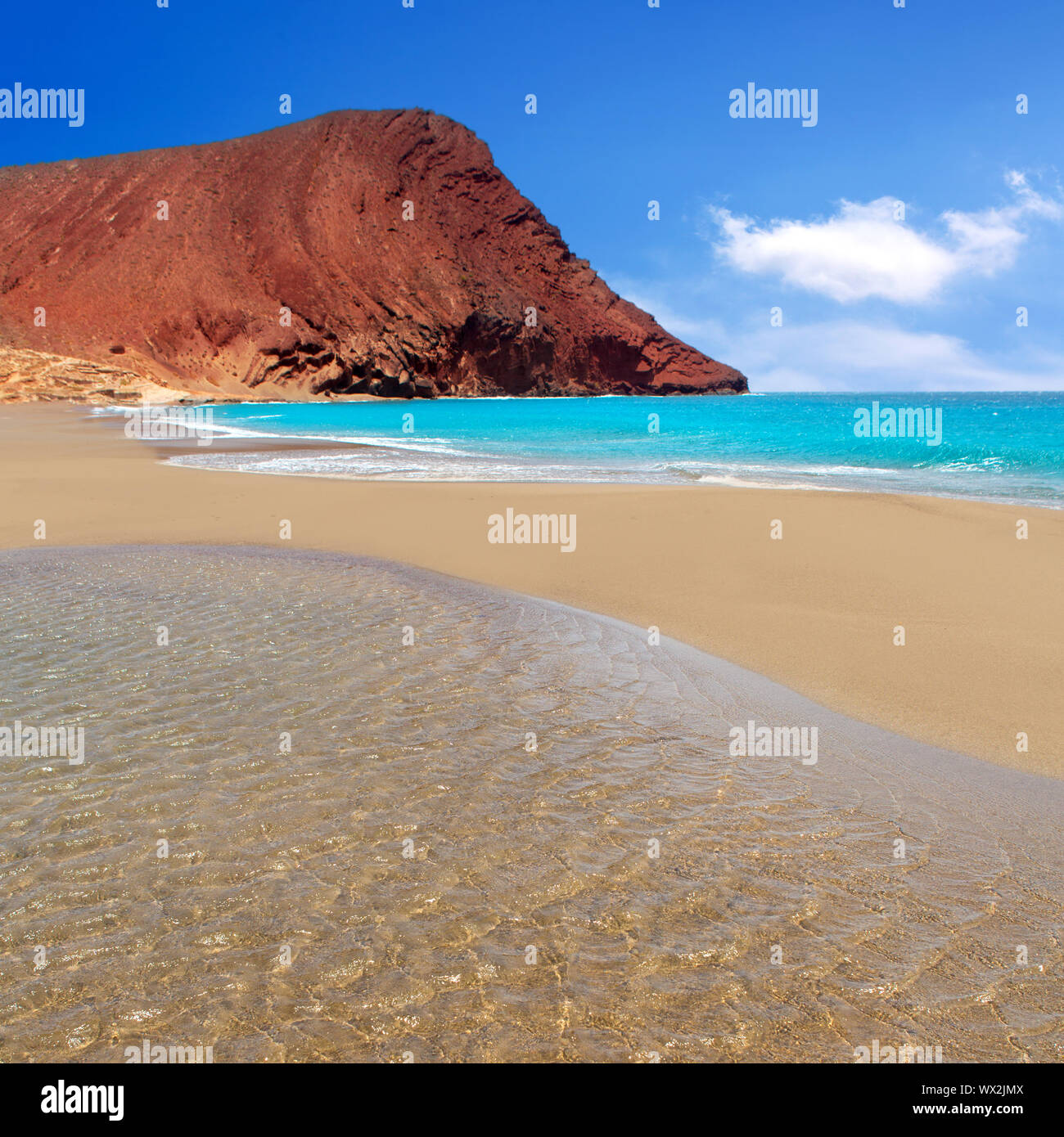 Beach Playa de la Tejita turquoise in Tenerife Canary islands with red ...