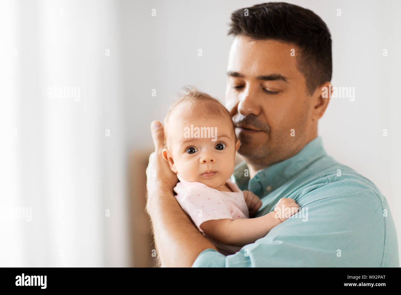 middle aged father with baby daughter at home Stock Photo - Alamy