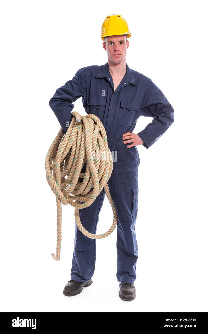 Worker in coverall and yellow helmet with large thick rope isolated on ...
