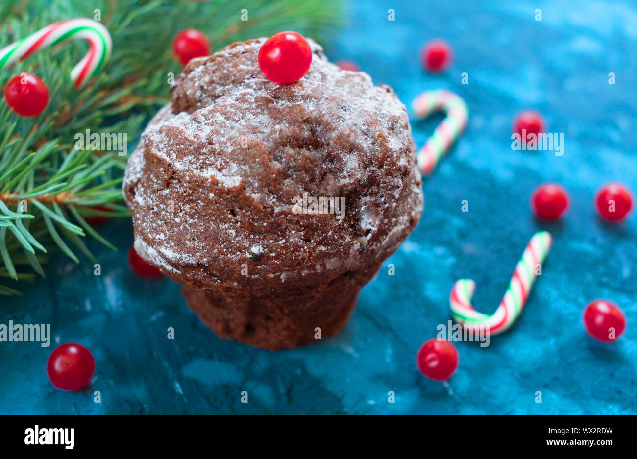 Christmas homemade chocolate muffin decorated with red berries and ...