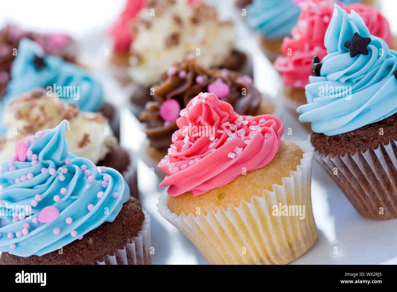 Assortment of brightly colored cupcakes Stock Photo - Alamy