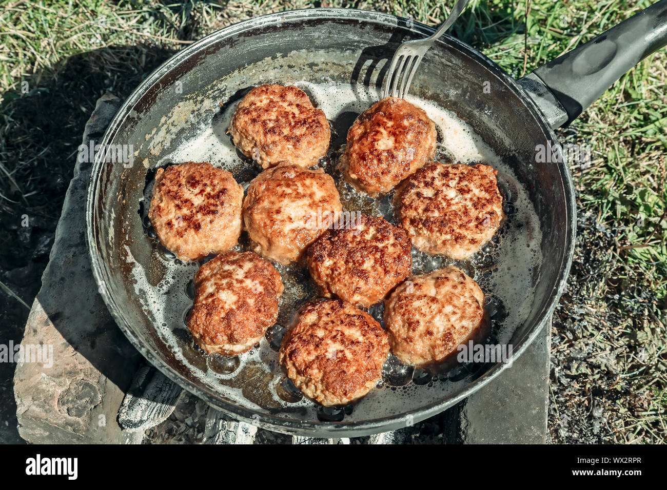 Cutlets fried in a pan over a fire Stock Photo - Alamy