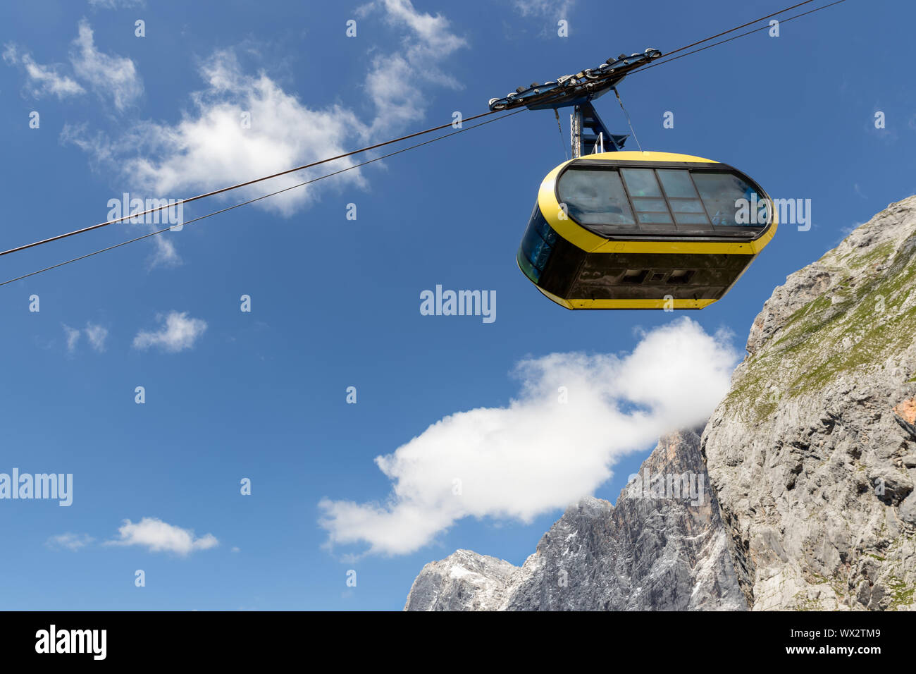 Cable car against blue sky in Austrian Alps Stock Photo - Alamy
