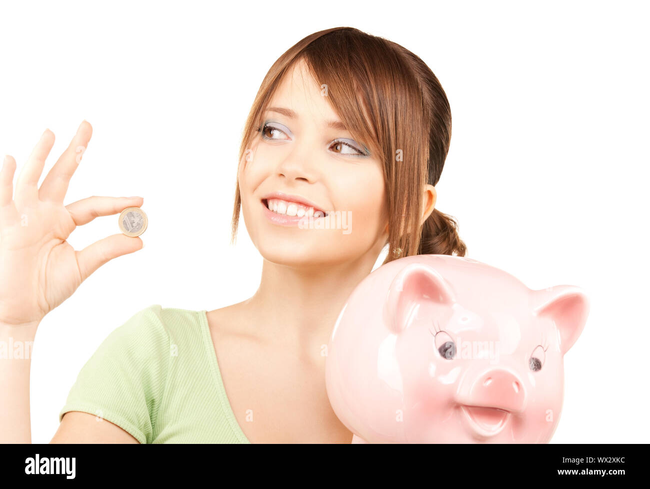 picture of lovely teenage girl with piggy bank and coin Stock Photo - Alamy