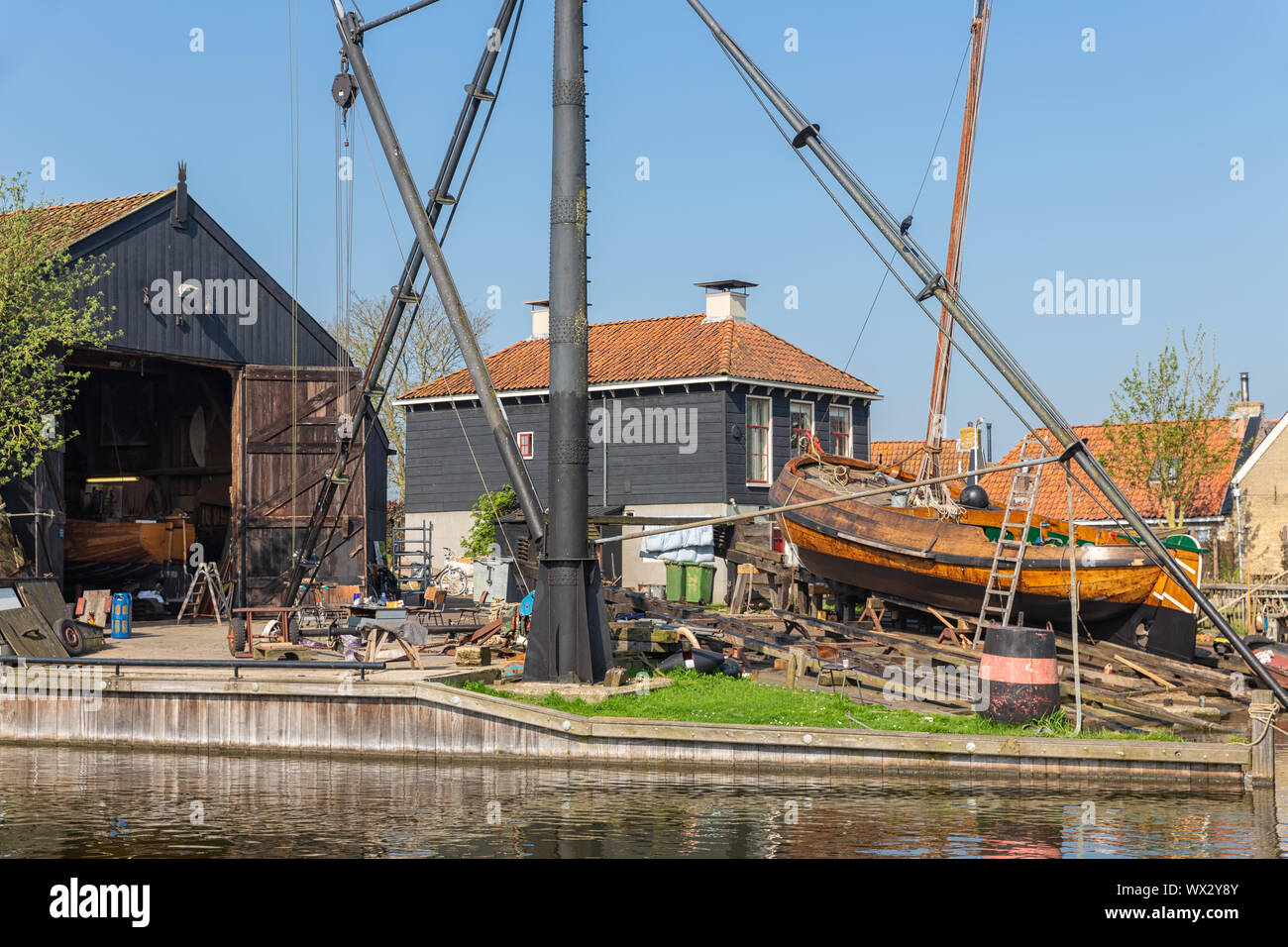 Historical ships at shipyard with slipway in Dutch village Workum Stock ...