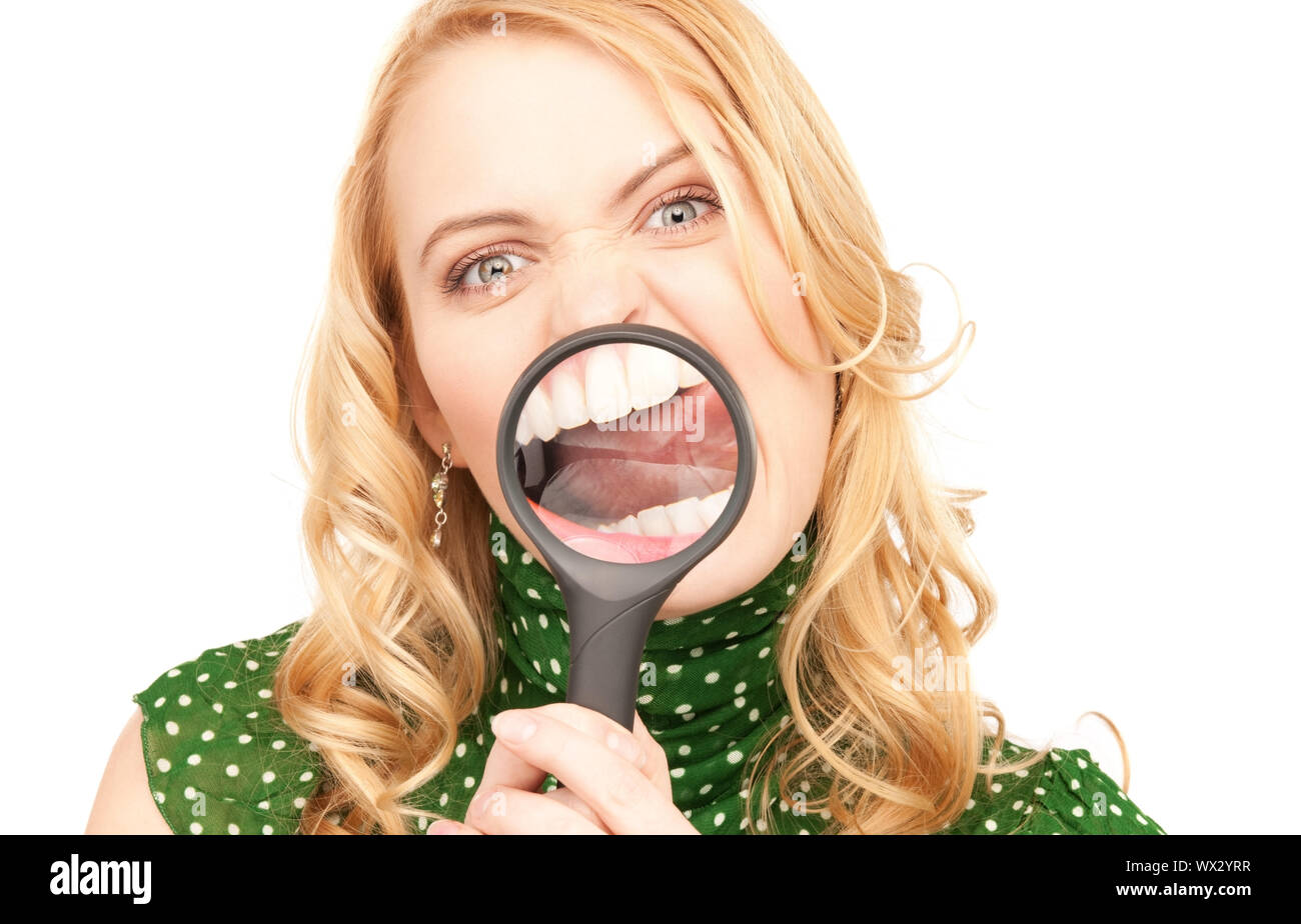 picture of woman with magnifying glass showing teeth Stock Photo - Alamy