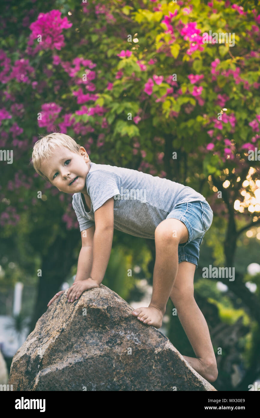 Funny boy on the rock Stock Photo - Alamy