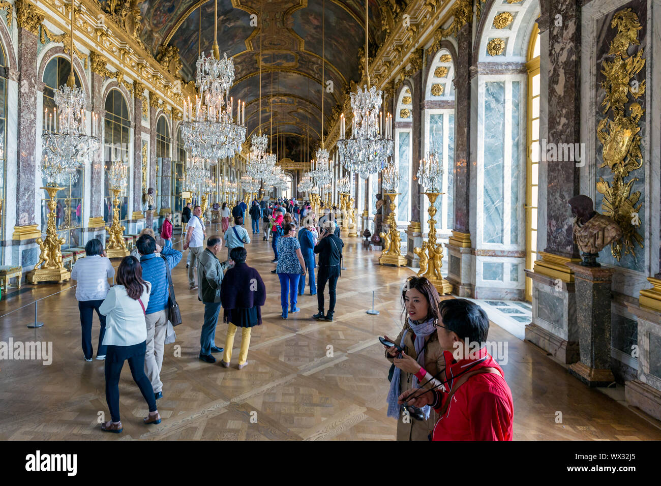Visitors admiring the Hall of Mirrors Palace Versailles near Paris ...