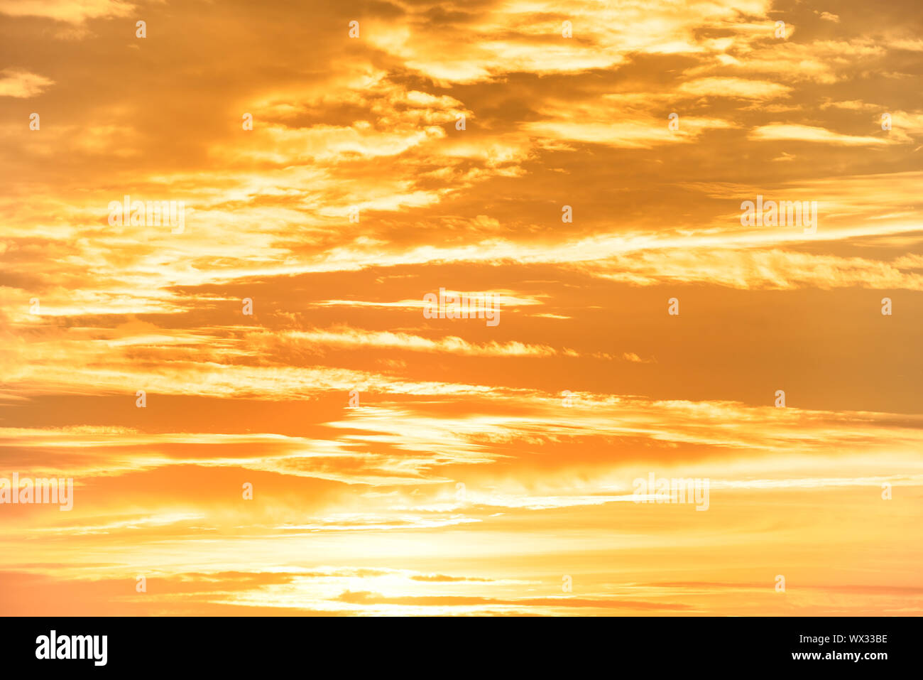 Orange sunset sky with clouds Stock Photo - Alamy