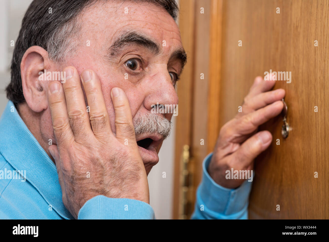 Looking through peephole hi-res stock photography and images - Alamy